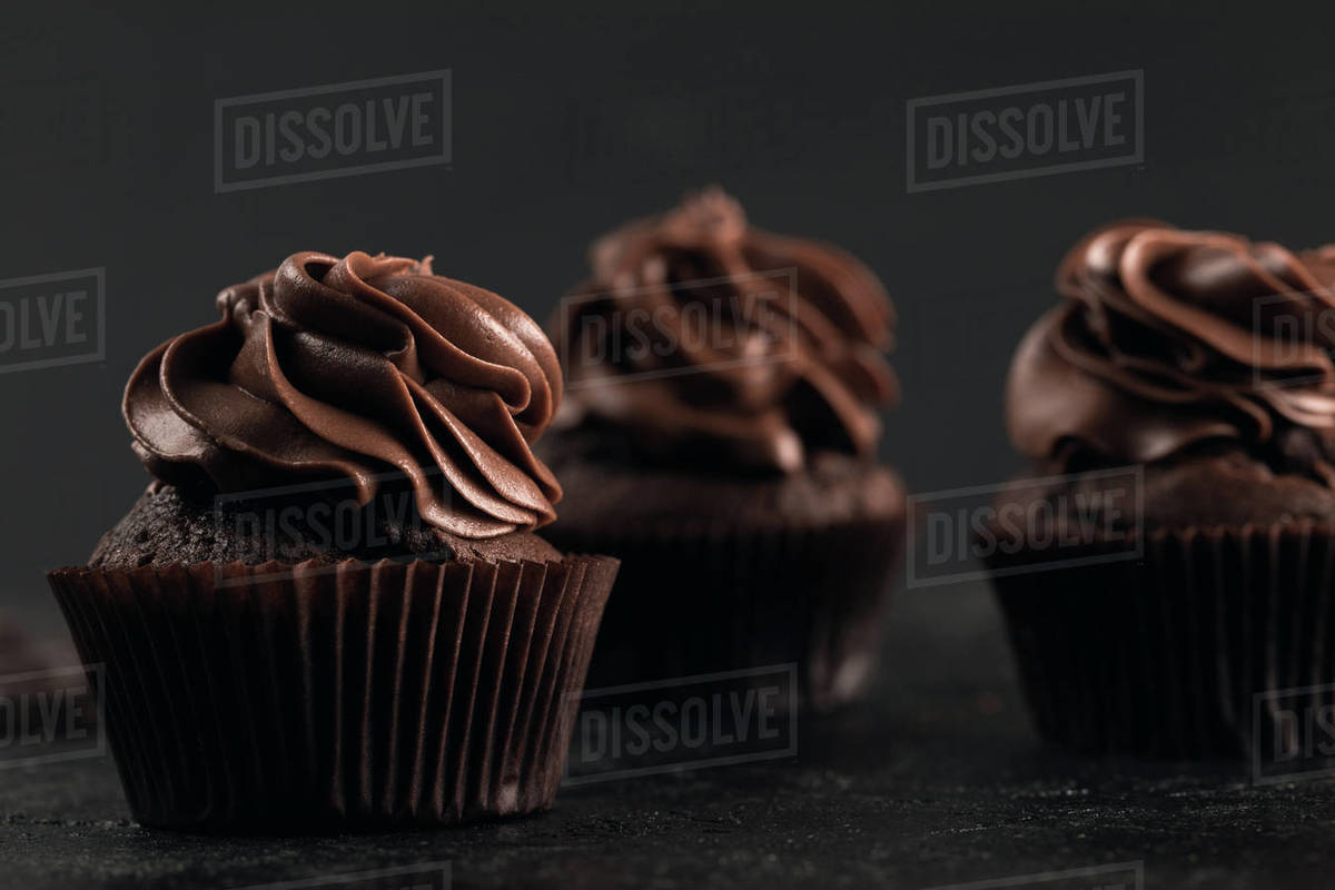 Close-up view of tasty homemade chocolate cupcakes on black - Stock ...