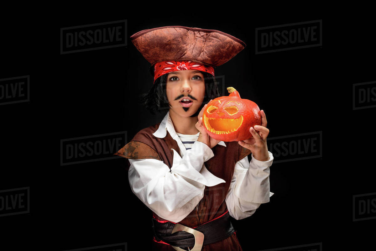 Child in Halloween costume of pirate with jack o lantern pumpkin ...