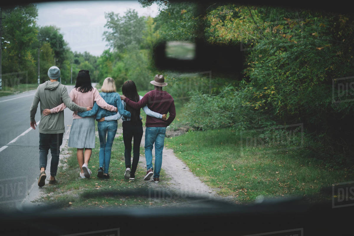 Back view of friends hugging and walking together - Royalty-free Stock ...