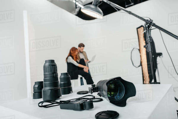 professional photographer and model with laptop in photo studio with ...