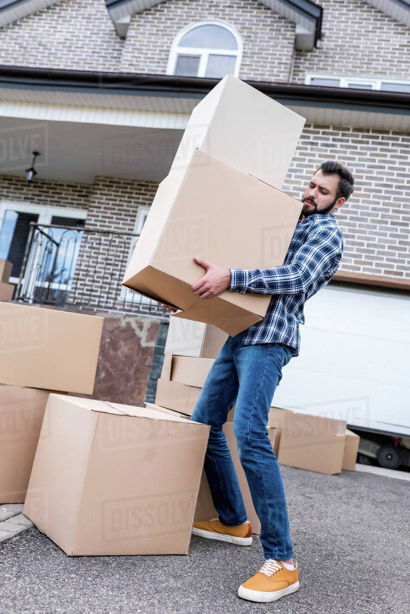 Young man moving into new house - Royalty-free Stock Photo | Dissolve