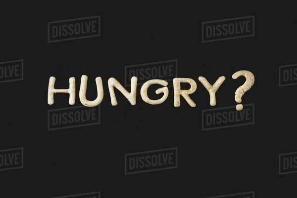 Top view of word hungry made from cookie dough isolated on black ...