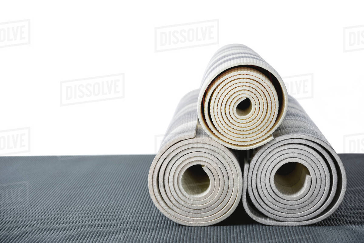 Yoga mats lying on grey mat isolated on white with copy space - Royalty ...