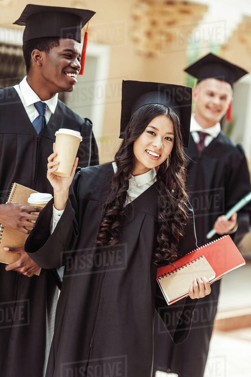 multiethnic graduated students with coffee and notebooks - Stock Photo ...