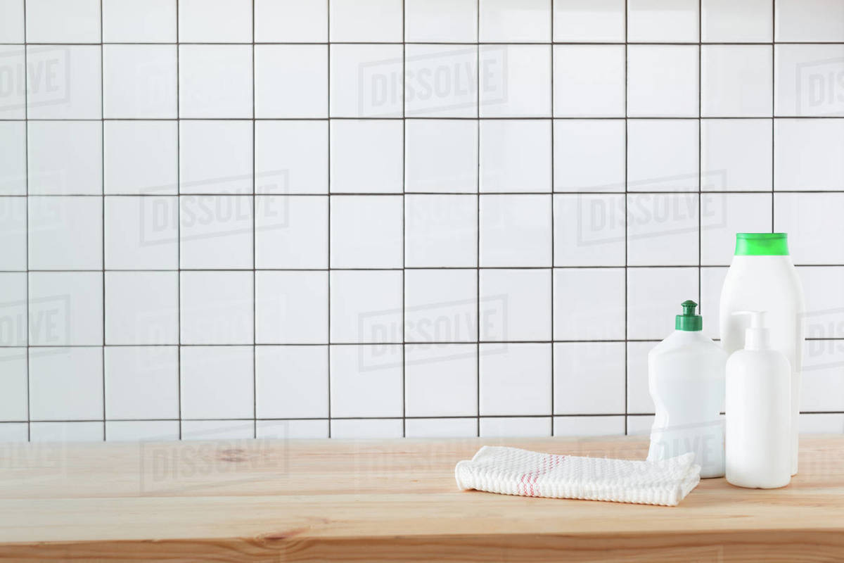 Plastic bottles with cleaning products and towel on tabletop - Royalty ...
