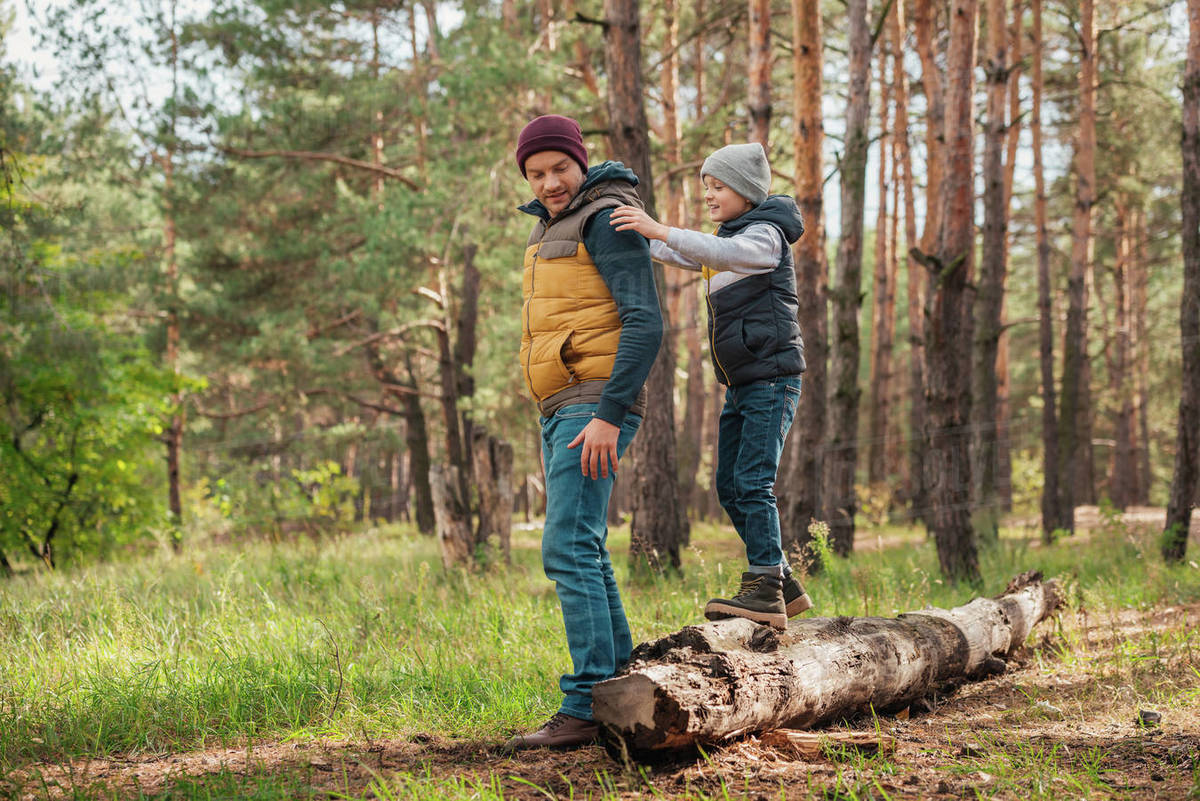 Happy father and son spending time together in autumn forest - Royalty ...