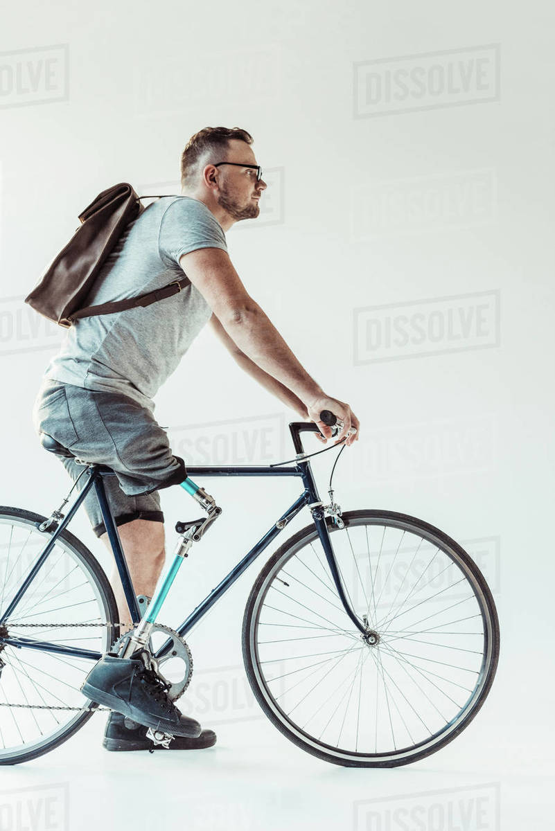Side view of man with backpack on bicycle isolated on white - Stock ...