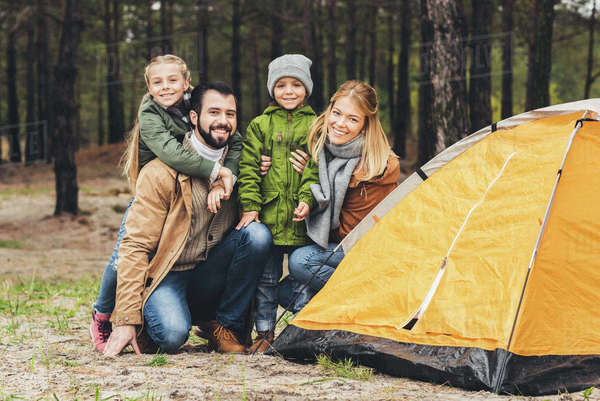 happy family having camping trip together in forest - Stock Photo ...