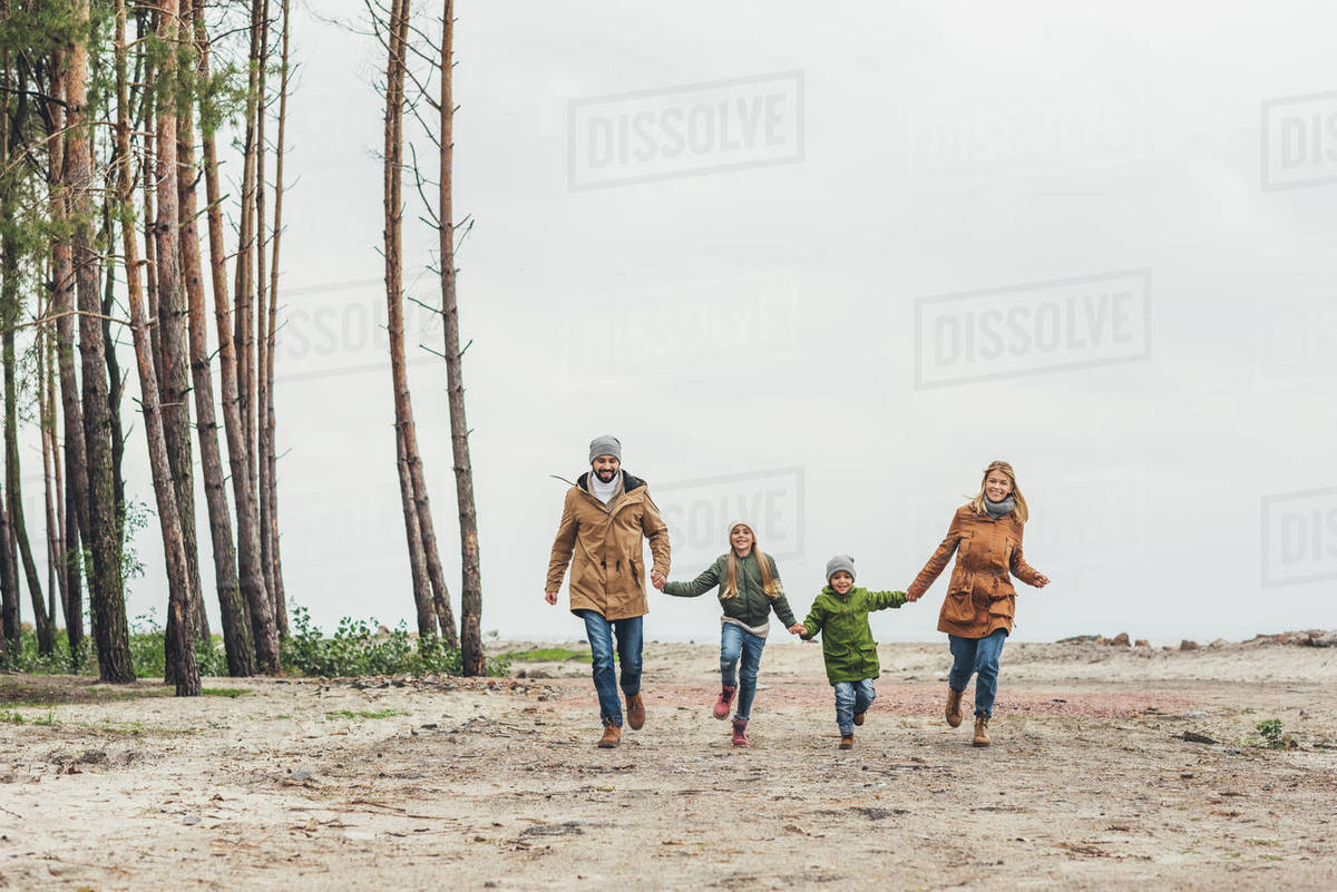 happy family running together and holding hands on nature - Royalty ...
