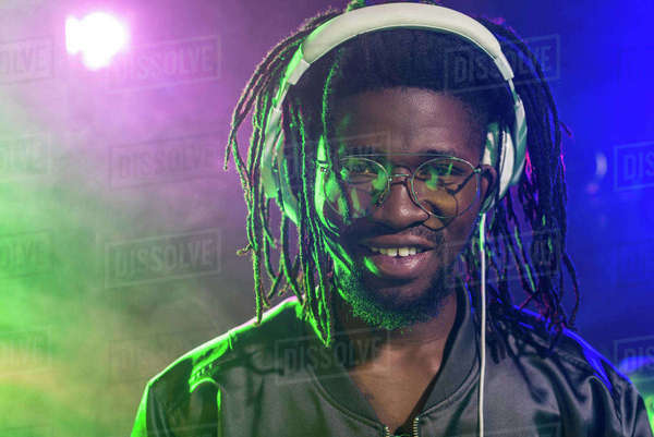 Professional African American dj in headphones in nightclub - Stock ...