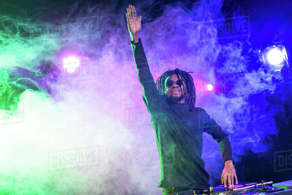 Professional African American club dj with sound mixer in nightclub ...