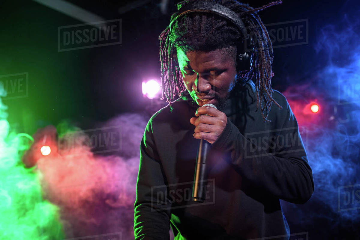 Professional African American club dj in headphones with microphone in ...