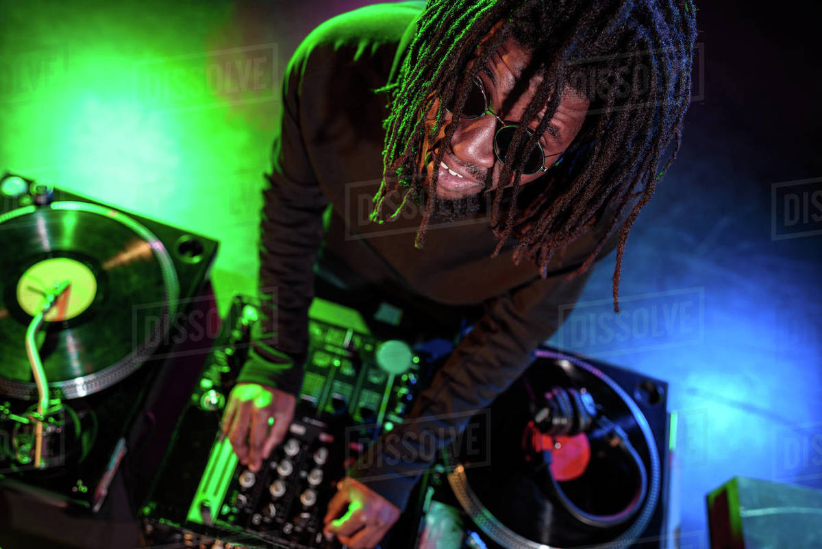 Professional African American dj with sound mixer in nightclub ...