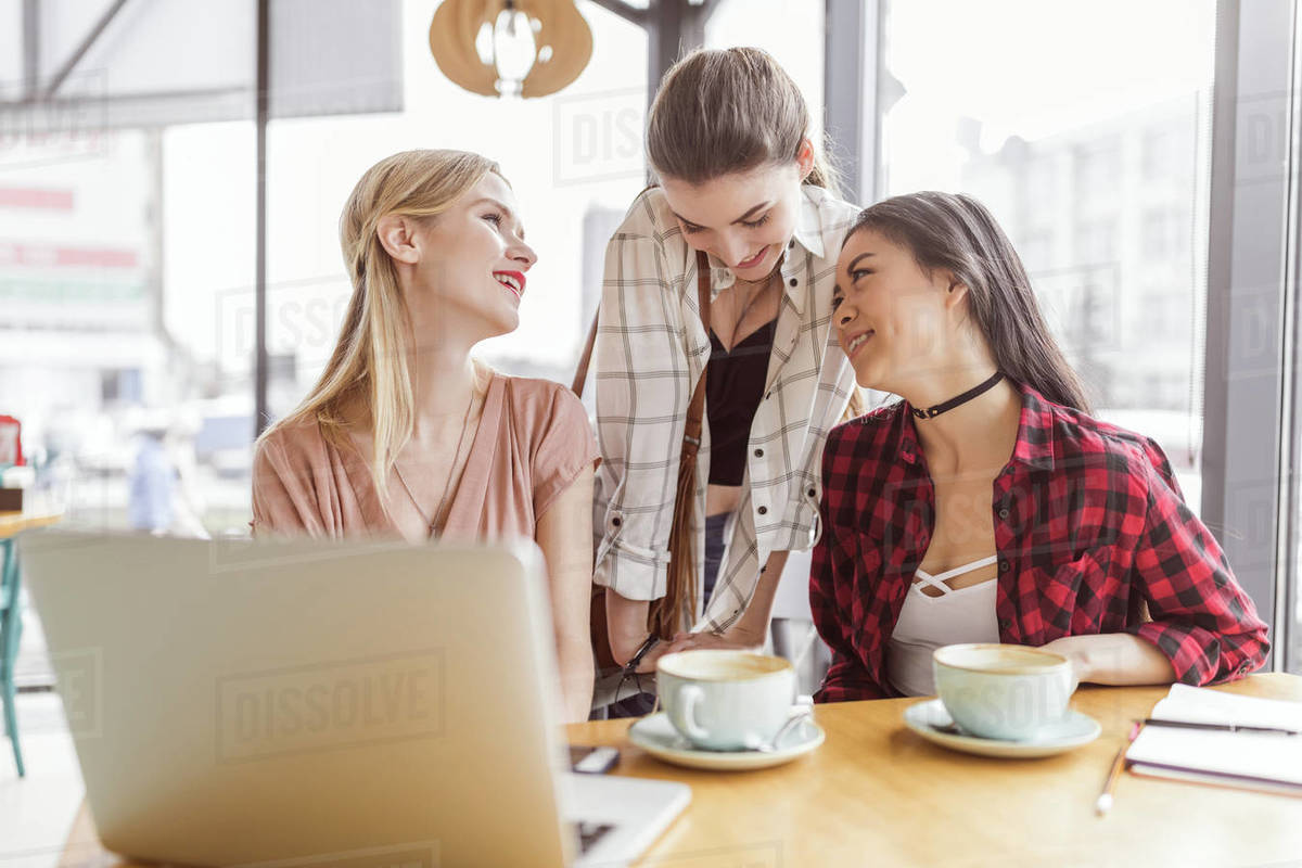 Group of stylish friends spending time together in cafe - Royalty-free ...