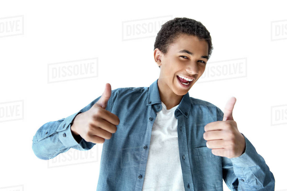 Portrait of excited African American teenager showing thumbs up ...