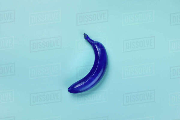 Top view of blue colored banana isolated on blue, colorful background ...