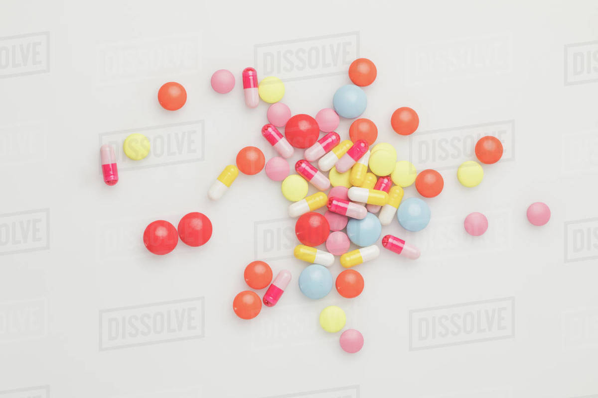 top view of scattered colored pills isolated on white - Stock Photo ...