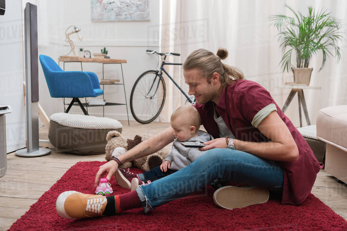 happy father playing toys with his little son at home - Royalty-free ...