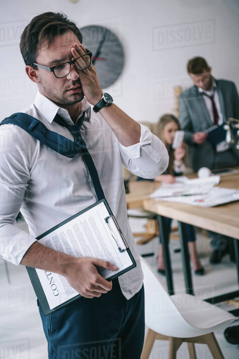 untidy overworked businessman with contract at office - Royalty-free ...