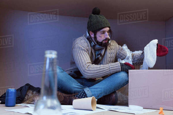 Homeless man sitting in cardboard box - Royalty-free Stock Photo | Dissolve