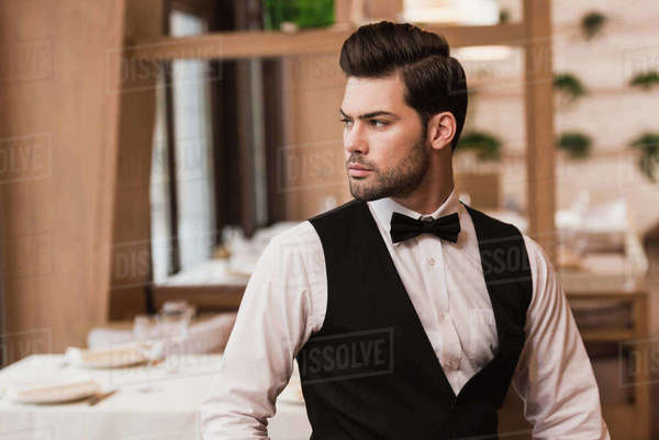 Portrait of handsome waiter looking away - Royalty-free Stock Photo ...