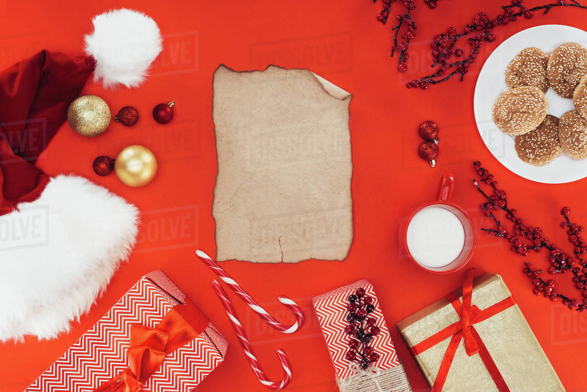 Top view of blank papyrus, christmas decorations, santa hat and ...
