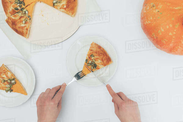 Top view of woman cutting slice of pumkin pie on plate isolated on ...