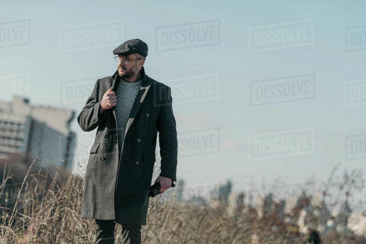 Handsome middle aged man in coat walking outdoors - Royalty-free Stock ...