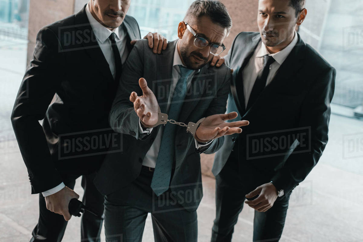 Arrested offender showing security guards shrug gesture - Royalty-free ...