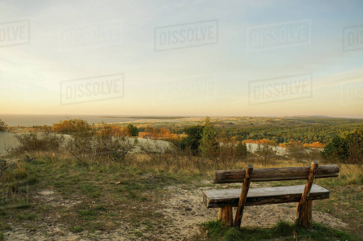 Countryside with river and wooden bench - Stock Photo - Dissolve