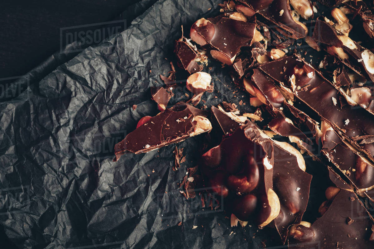 Top view of dark chocolate with nuts on gray wrapper - Stock Photo ...