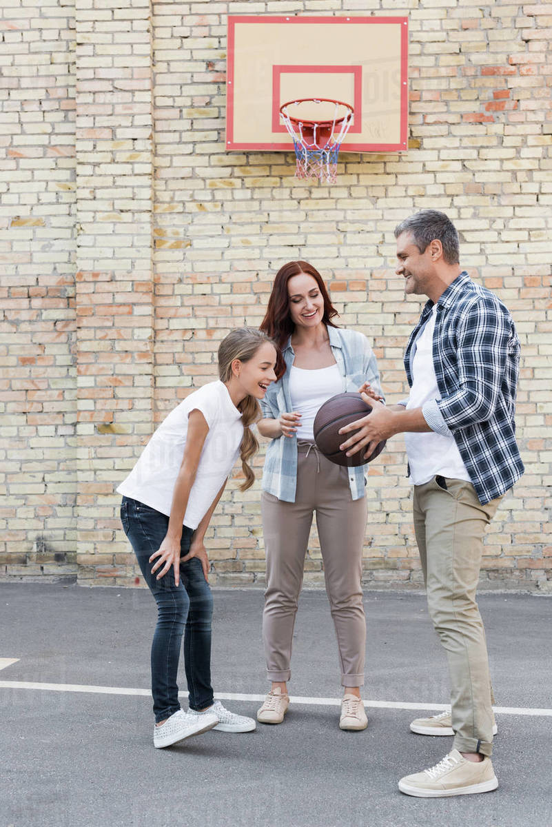 Happy family playing basketball together on playground - Royalty-free ...