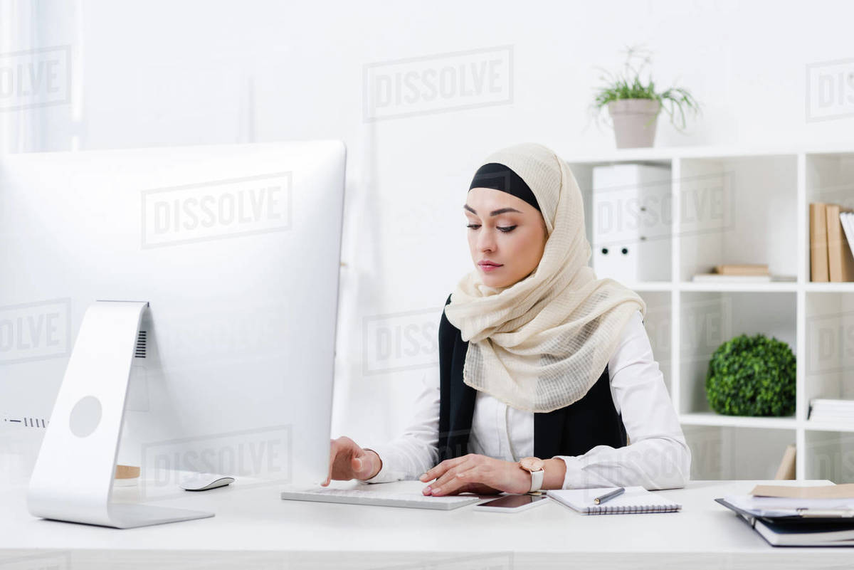 portrait of focused muslim businesswoman working on computer in office ...