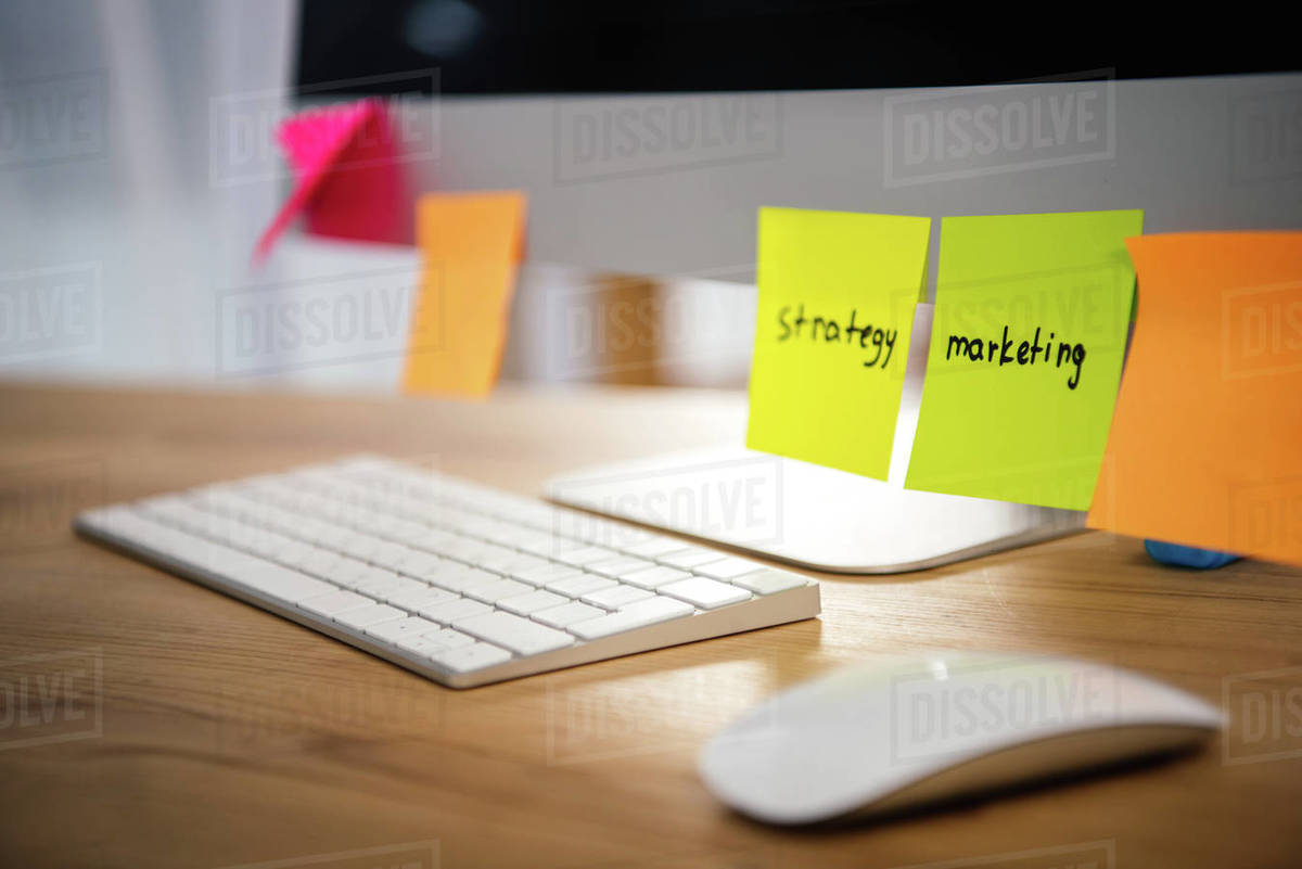 Close up view of colorful sticky notes with marketing and strategy ...