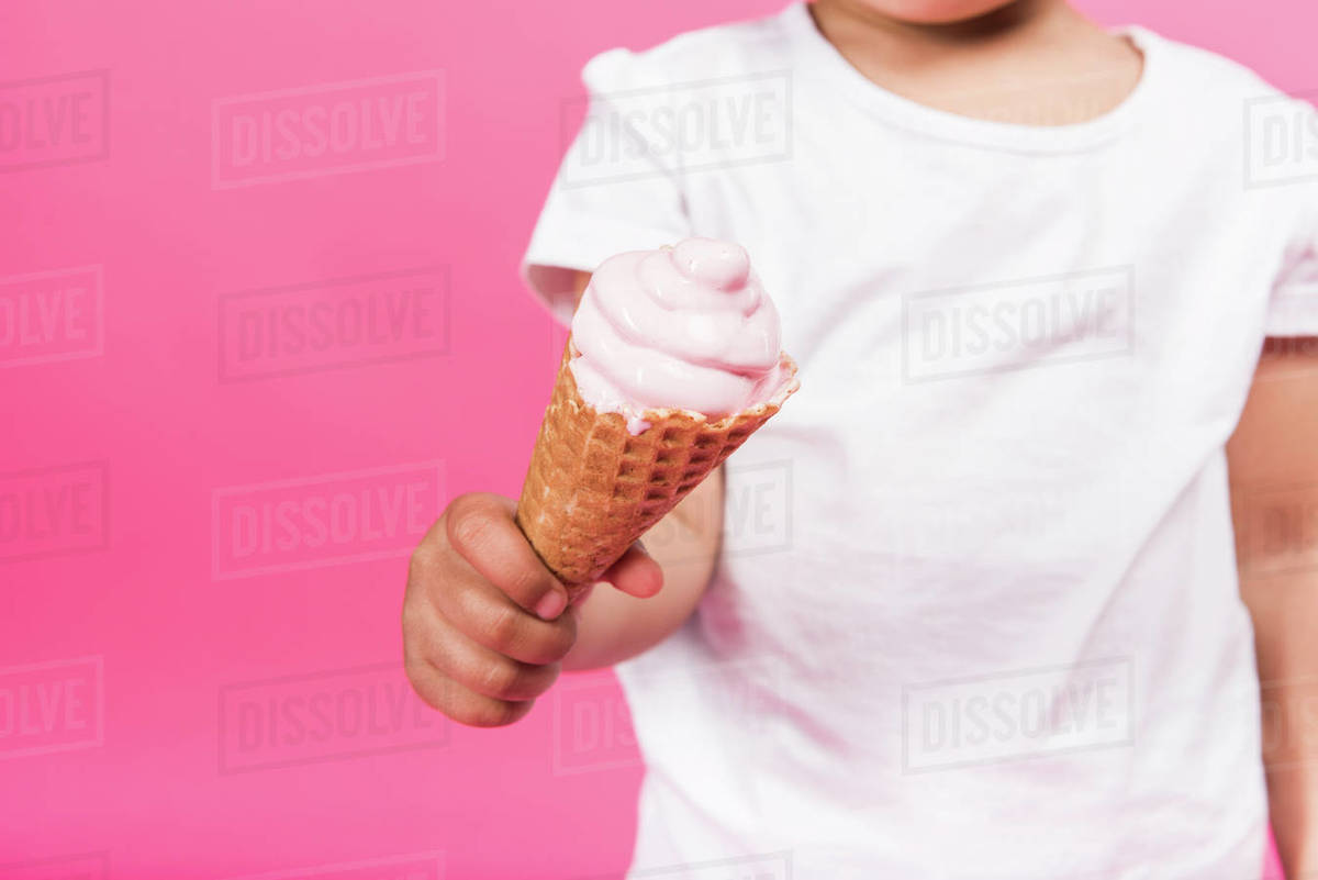 Cropped image of preschooler kid holding ice cream in a hand isolated ...