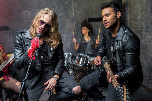 Young rock band rehearsing in musical studio, band on stage concept ...