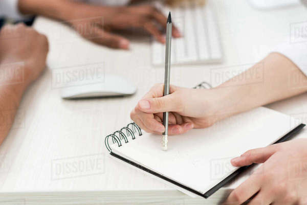 Cropped shot of students doing task together during lesson - Royalty ...