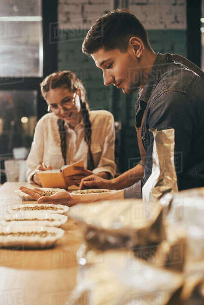 Selective focus of coffee shop workers checking coffee quality during ...