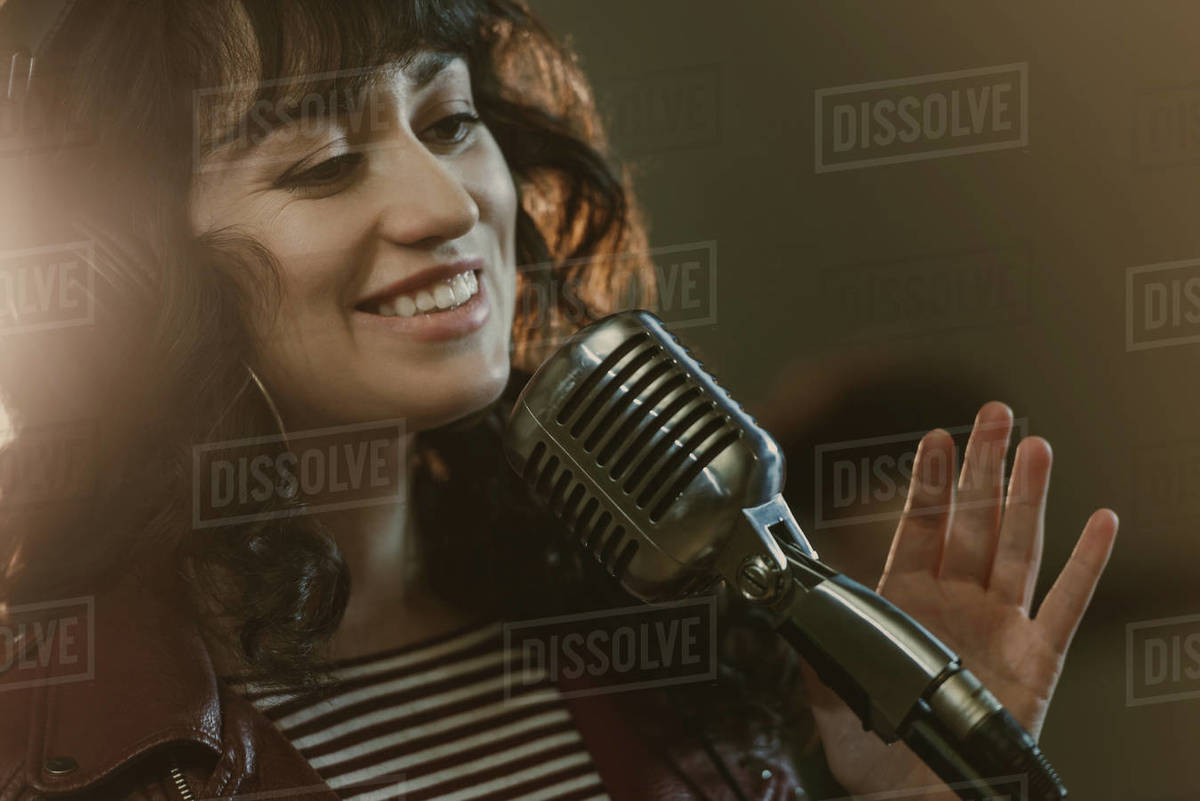 attractive young female singer performing song and smiling - Royalty ...