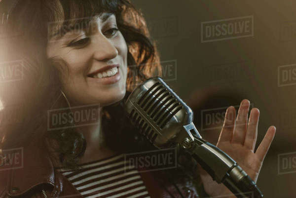 attractive young female singer performing song and smiling - Royalty ...