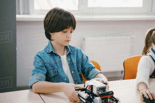 serious little kid making diy robot, stem education concept - Royalty ...