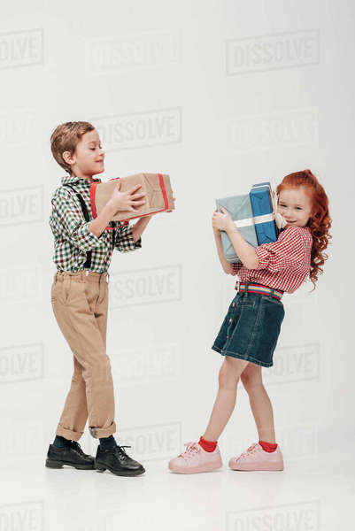 adorable little kids holding colorful gift boxes isolated on grey ...