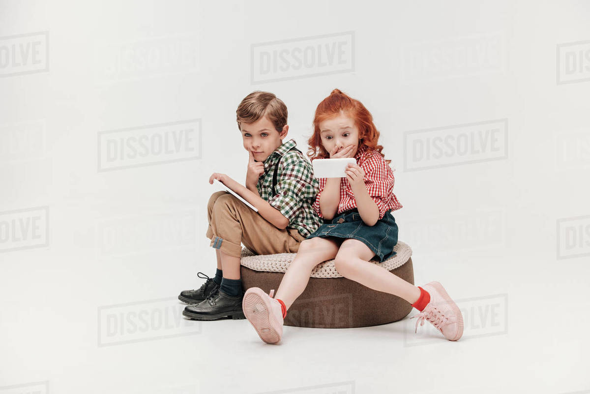 beautiful little children using digital devices isolated on grey ...