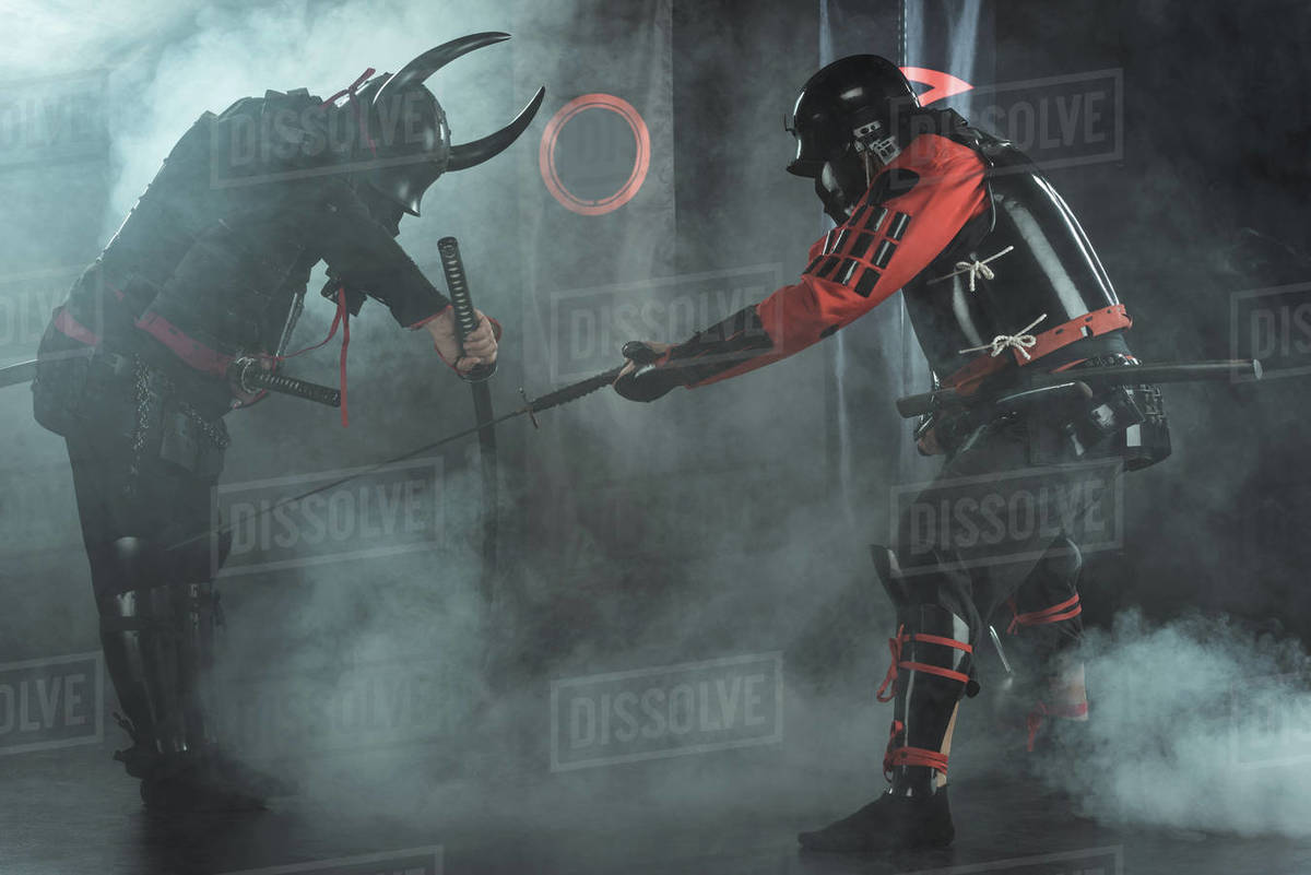 Armored samurai fighting with swords surrounded with smoke in front of ...