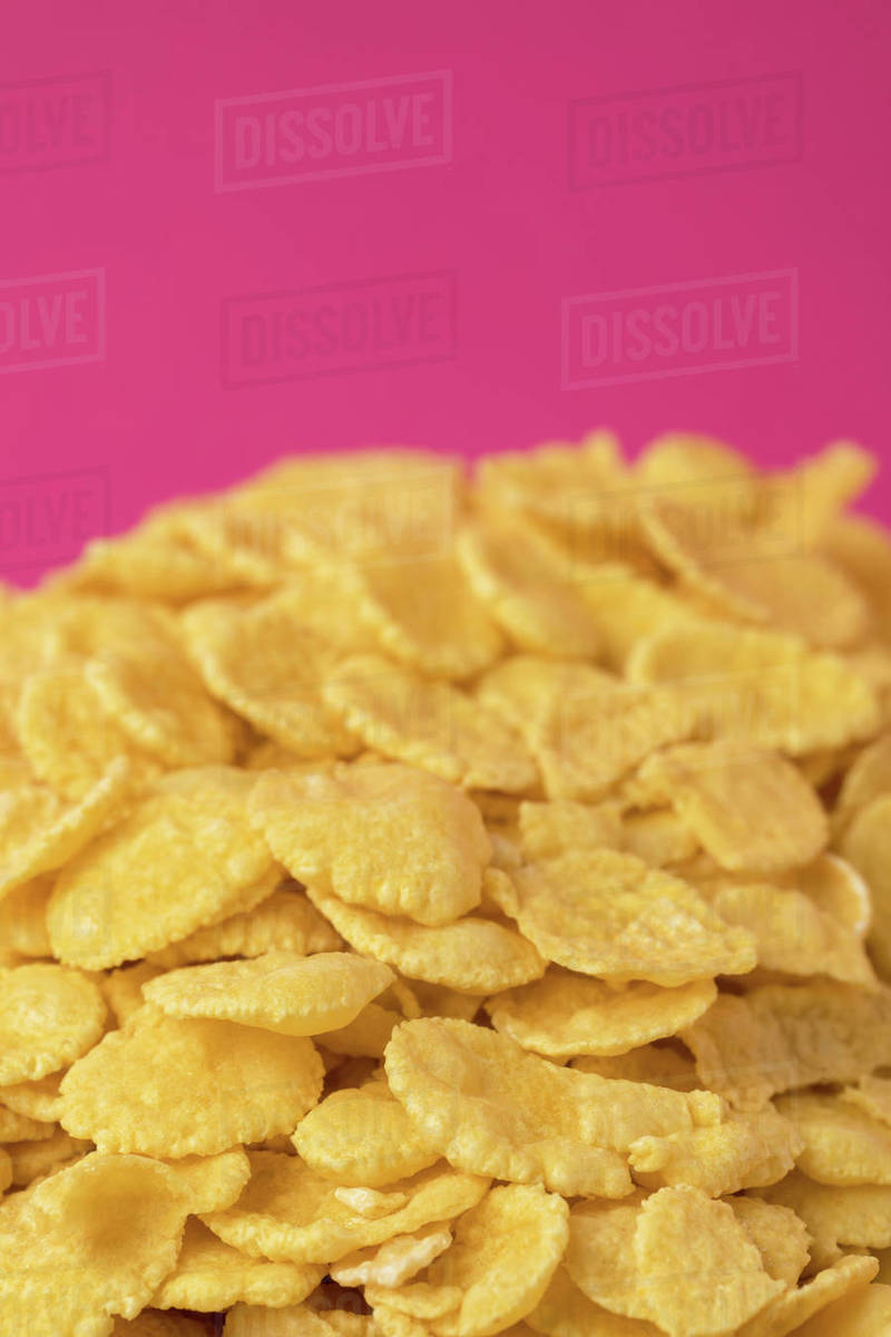 Selective focus of sweet tasty corn flakes isolated on pink - Royalty ...