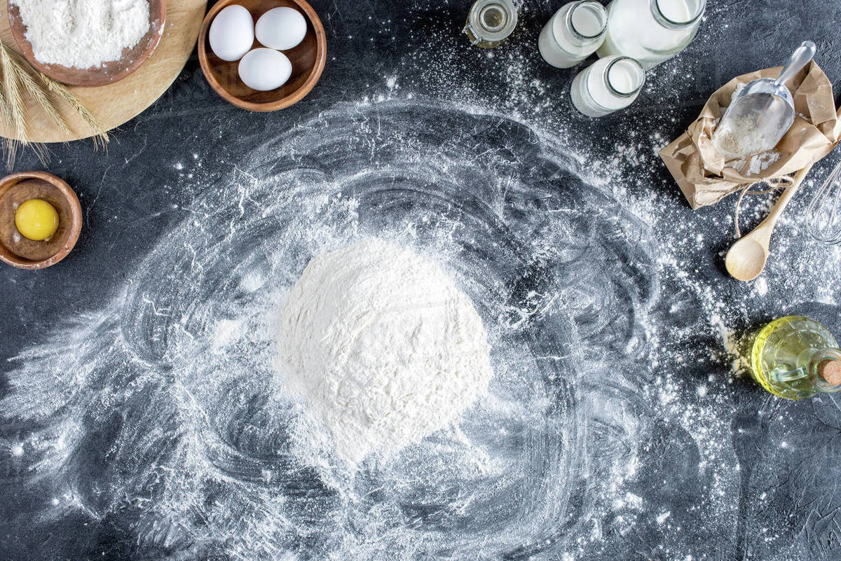 Flat lay with flour and other ingredients for bakery, kitchenware on ...