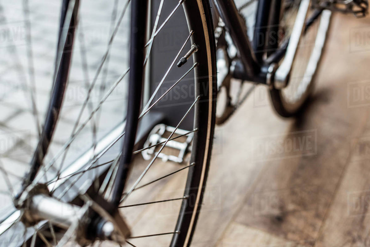 Cropped image of bicycle on wooden floor in house - Royalty-free Stock ...