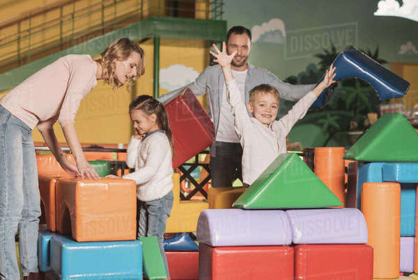 happy family with two kids building castle with colorful blocks at ...