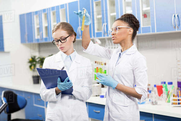 Portrait of scientists working with test tubes, laboratory researcher ...