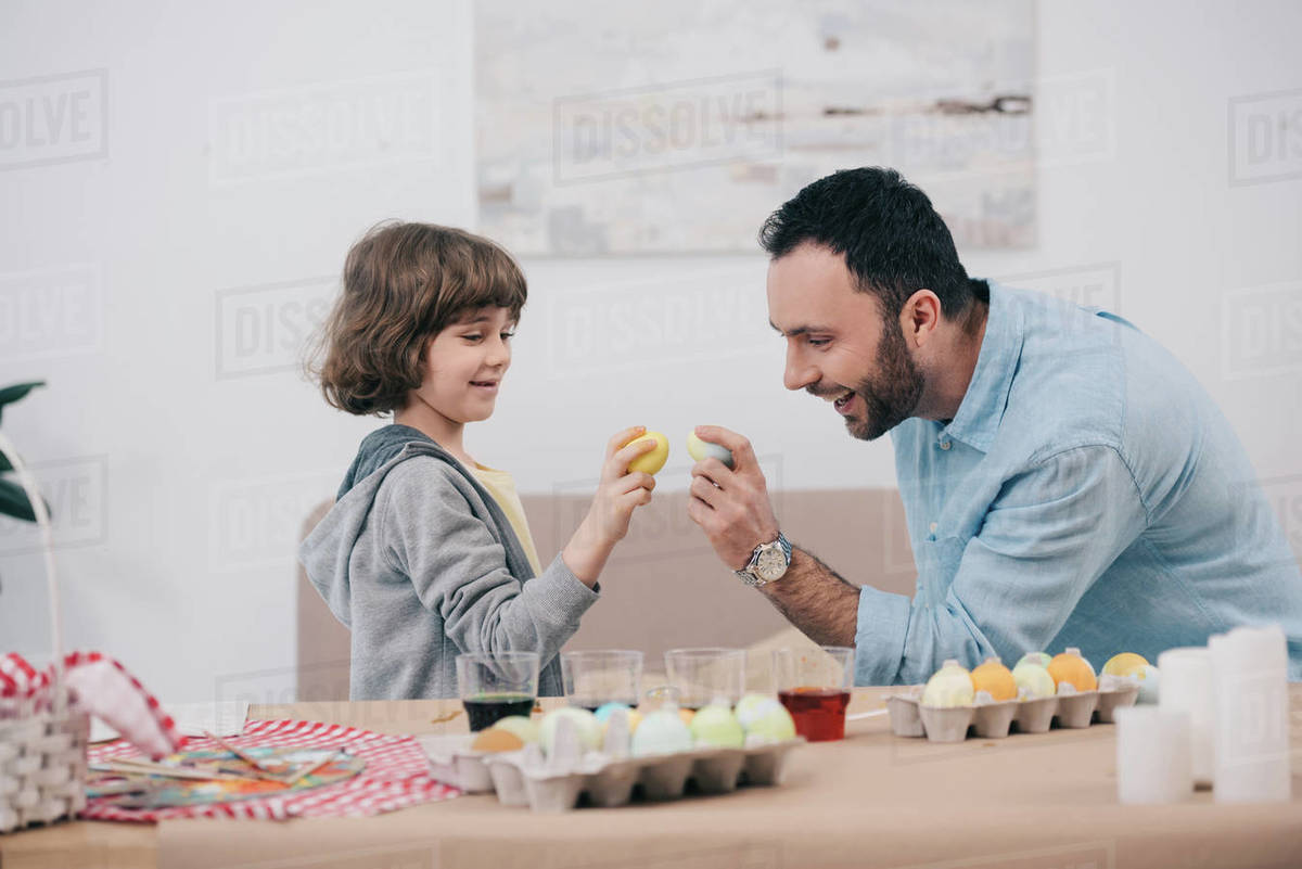 Father and son doing easter egg knocking - Stock Photo - Dissolve